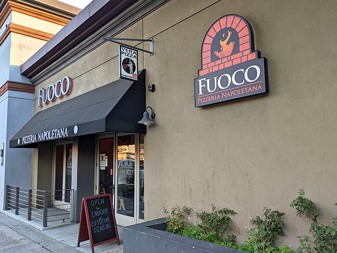 The storefront may be unassuming, but that logo tells you everything – fire-kissed pizza made with passion awaits just beyond those doors.