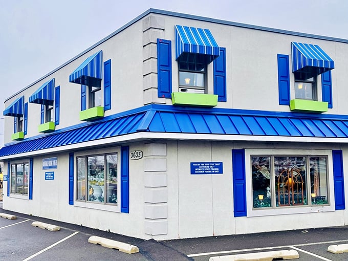 The cheerful blue-trimmed exterior promises treasures within. First impressions matter, even in the thrift store world!