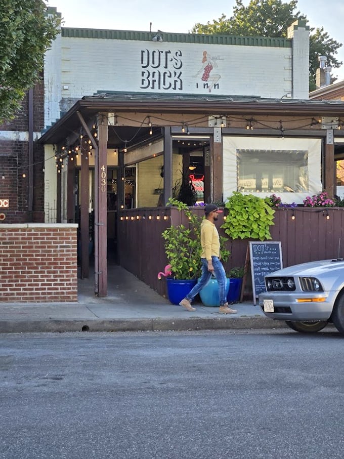 Dot's storefront at golden hour—when the white brick glows, string lights twinkle, and hungry Richmonders arrive for their comfort food fix.