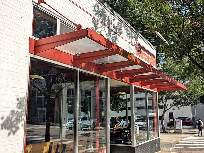 Beasley's modern storefront beckons with its bright red awning – a crispy chicken sanctuary hiding in plain sight on Raleigh's bustling streets.