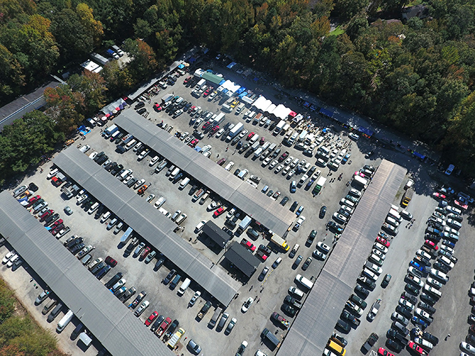 Aerial view of Bill's Flea Market reveals a sea of cars and canopies—treasure hunting central where bargain fever is highly contagious!