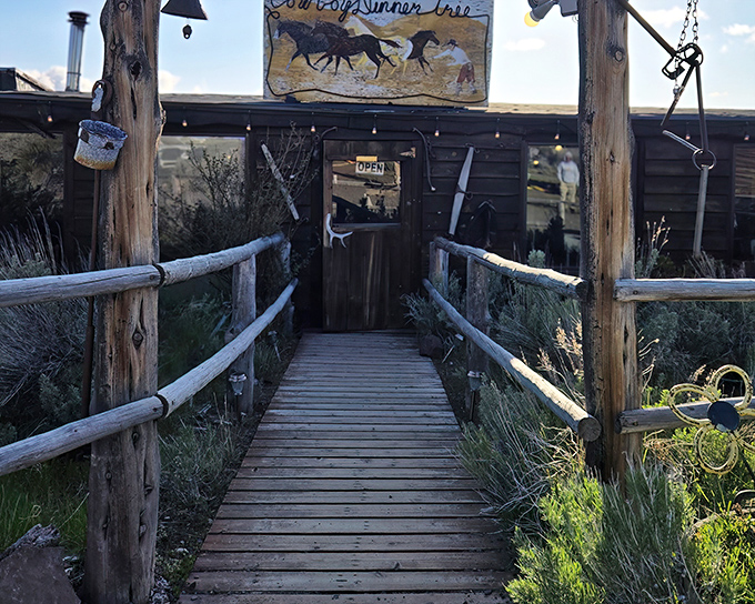 The entrance to Cowboy Dinner Tree beckons like a portal to the Old West. That wooden walkway practically whispers, "Come hungry, leave happy."