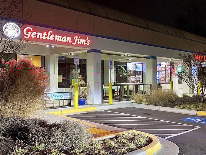 Gentleman Jim's glowing red sign beckons like an old friend at night. This Gaithersburg landmark promises pizza comfort that feels like coming home.