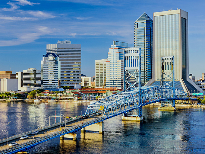 Jacksonville's skyline gleams like a hidden treasure, with that iconic blue bridge stretching across the St. Johns River like a welcome mat to affordability.