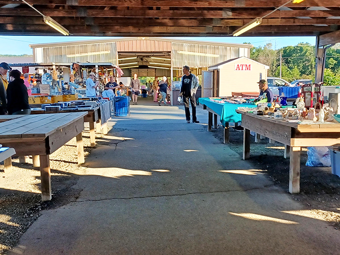 Treasure hunters navigate the covered walkways of Jake's Flea Market, where bargain dreams come true under rustic wooden beams.