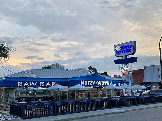 Noizy Oyster's blue awning promises seafood paradise as the sun sets. Raw bar outside, seafood heaven inside!