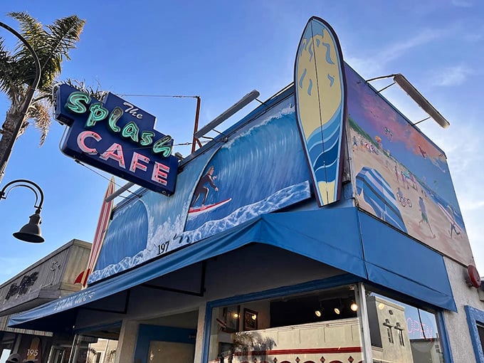 The iconic blue facade of Splash Café beckons seafood lovers with its whimsical surf-themed sign. Beach dining doesn't get more authentic than this!