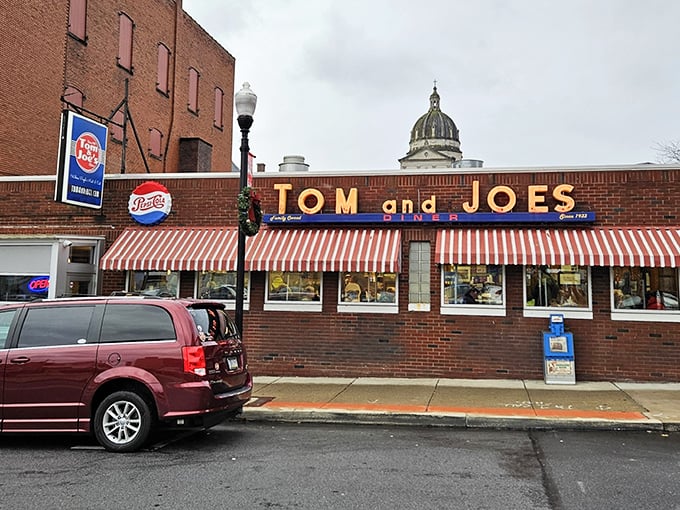 Tom & Joe's iconic storefront beckons with its red-and-white awnings – like a time machine disguised as a diner.
