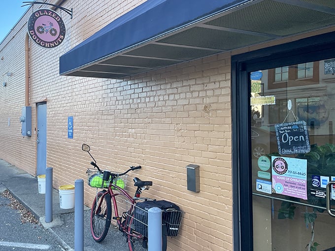 A bicycle parked outside Glazed Doughnuts – someone clearly knows the best way to earn those extra calories. Smart thinking!