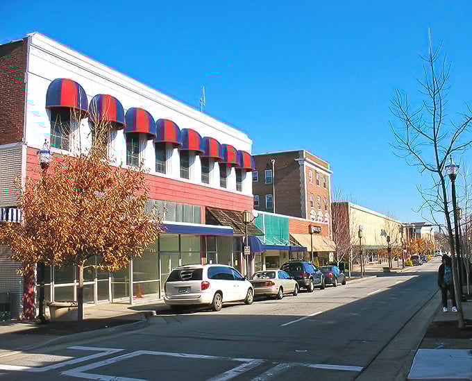 Red and blue awnings pop against classic storefronts in downtown Martinsville. This is Main Street as it should be—inviting, walkable, and full of local character.
