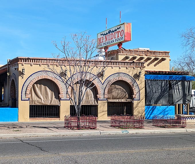 The desert sun highlights Mi Nidito's classic sign, promising comfort food that hugs your soul. Like finding a familiar face in a crowd.