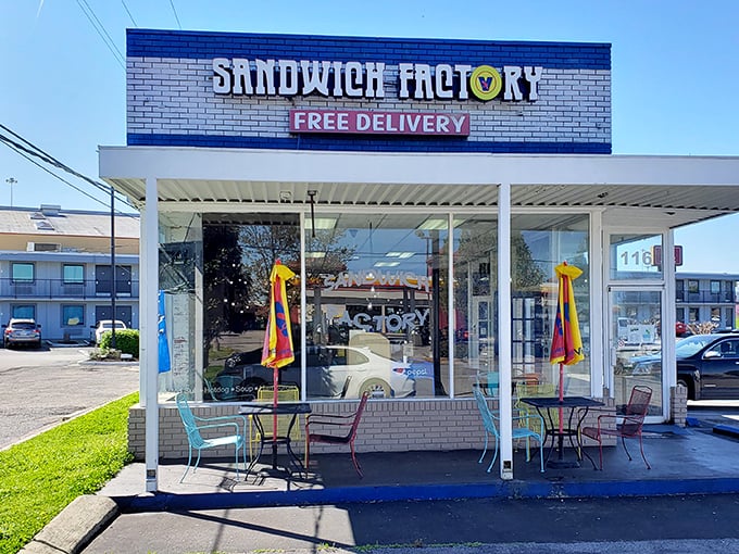 Those colorful outdoor tables aren't just for show—they're front-row seats to the sandwich symphony happening behind those unassuming glass doors.