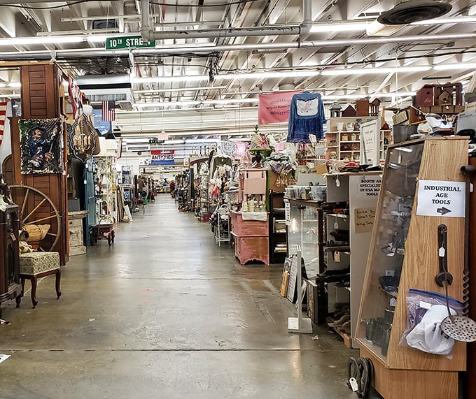 Street signs guide your journey through this antique wonderland, where every booth is its own little neighborhood of nostalgia.
