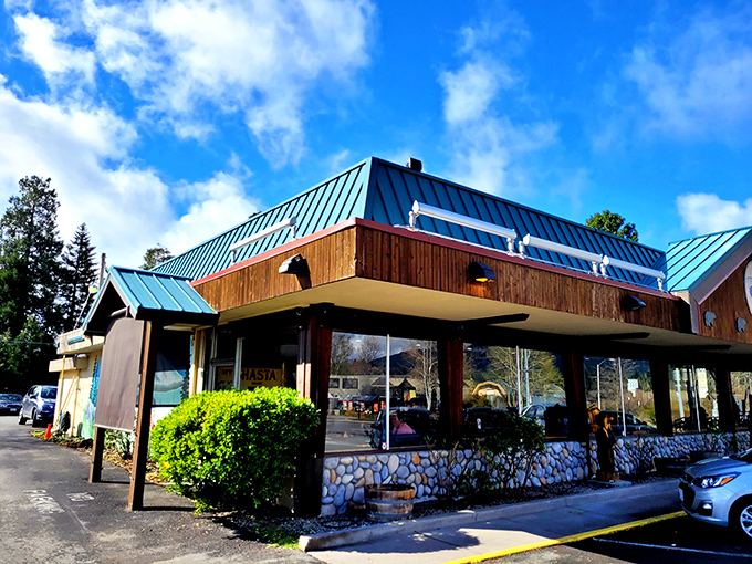 This isn't just any roadside diner—it's where locals gather for hearty breakfasts before mountain adventures. Blue roof, stone foundation, comfort food paradise.