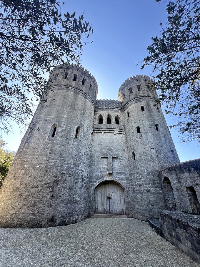 The imposing front facade creates a perfect medieval silhouette against the Florida sky, complete with crenellated towers and a cross that hints at its spiritual purpose.