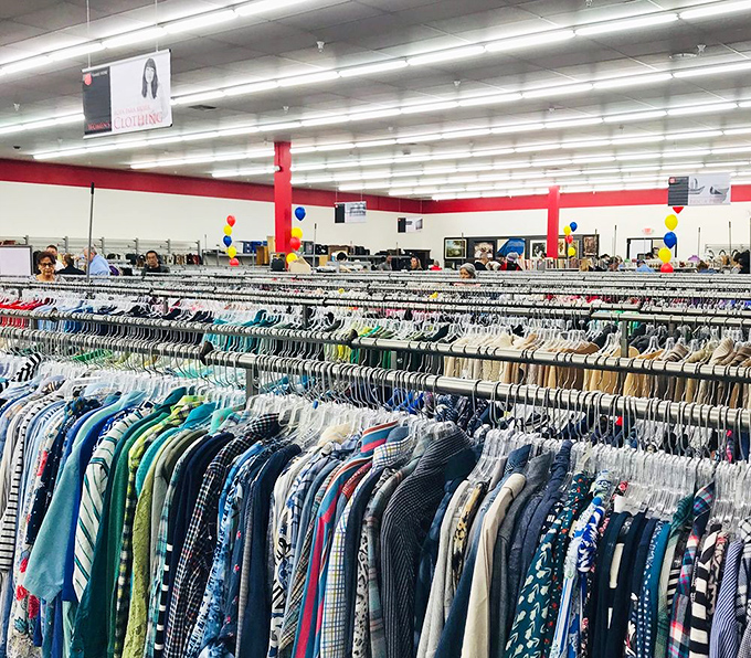 A textile treasure hunt awaits! Rows upon rows of neatly organized clothing create a rainbow of possibilities for fashion-forward thrifters.