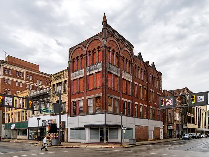 This corner building could be straight out of a Wes Anderson film – architectural eye candy with those arched windows and that distinctive red brick charm.