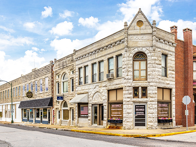 The E.K. Knell Building stands as a limestone testament to when architecture had personality. That corner entrance practically begs you to step inside and explore.