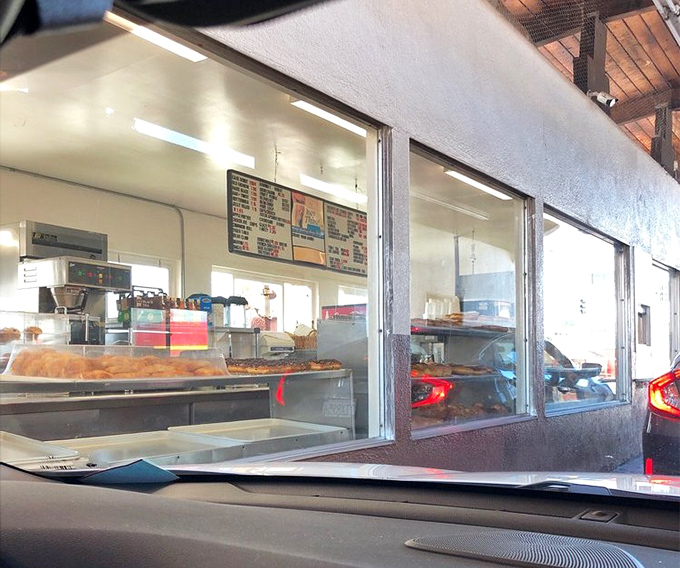 Where dreams come true, one window at a time. That magical moment when you exchange cash for fresh donuts without ever leaving your car—modern convenience meets old-school indulgence.
