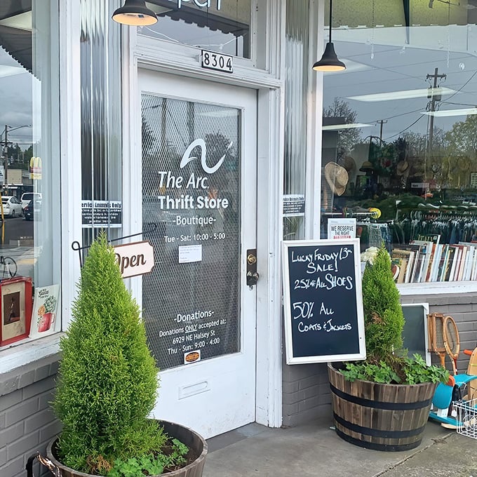 Flanked by cheerful greenery, the entrance promises adventure with its handwritten sales board—25% off shoes and 50% off coats? I'm already reaching for my wallet!