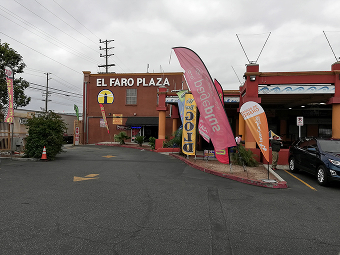 Morning light catches the colorful banners outside El Faro's entrance – nature's way of saying "sale in progress" without the annoying email notifications.