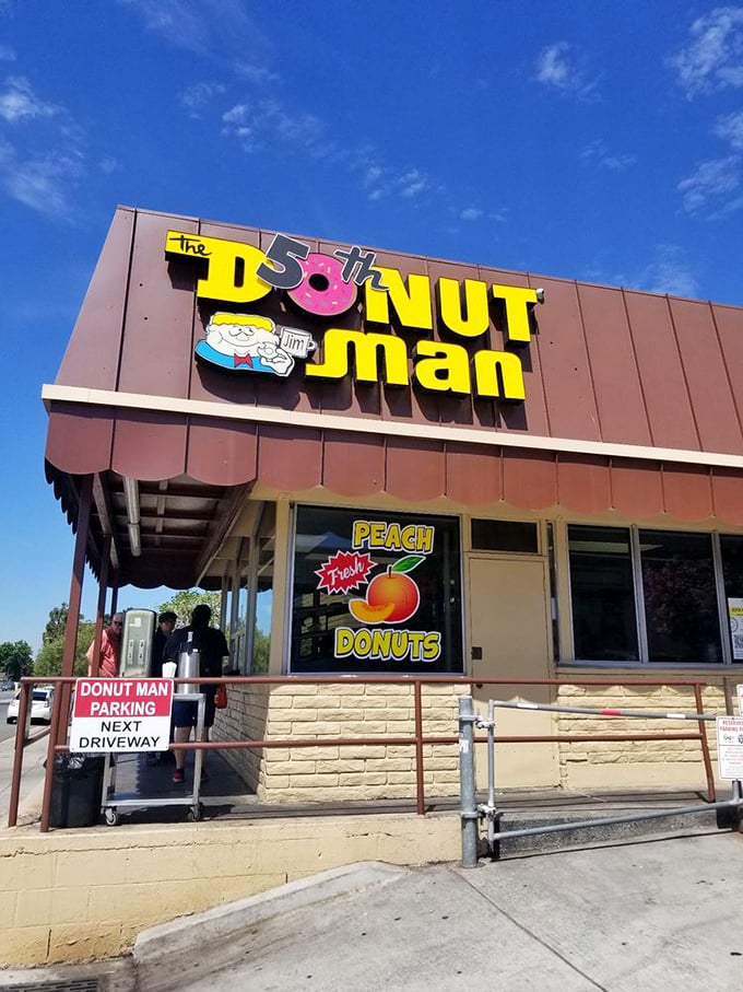Behold the temple of fried dough! The iconic sign promises peach-filled treasures that make waiting in line a pleasure, not a chore.