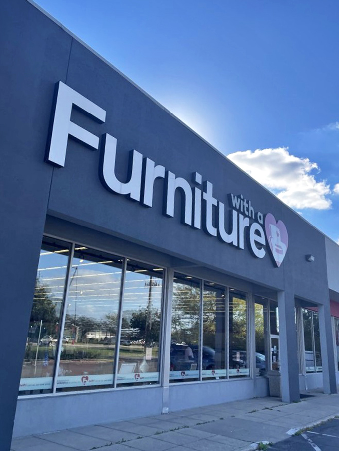 Blue skies, big savings. The modern storefront of Furniture with a Heart beckons bargain hunters with its clean lines and welcoming heart logo.
