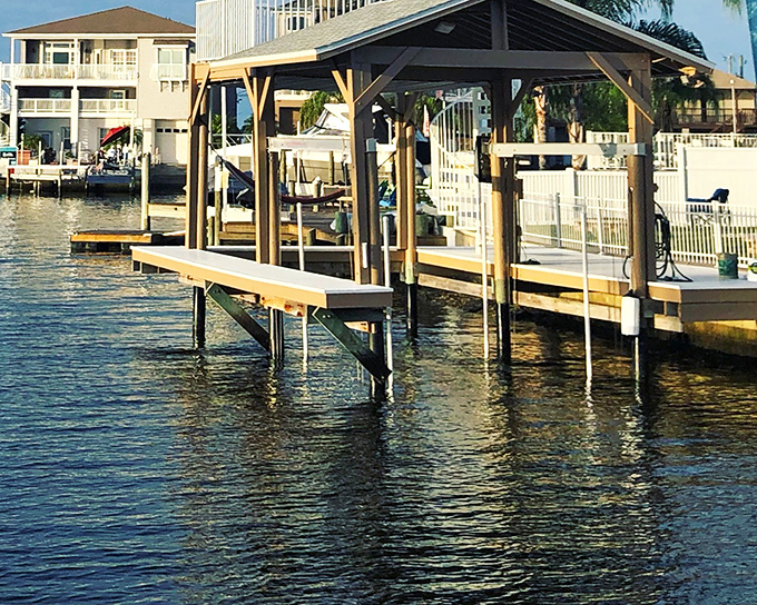 A covered boat dock that says "Florida retirement" more clearly than any brochure ever could. 