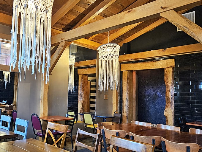 Rustic wooden beams meet elegant macramé chandeliers in this delightfully eclectic dining room where mismatched chairs somehow create perfect harmony.