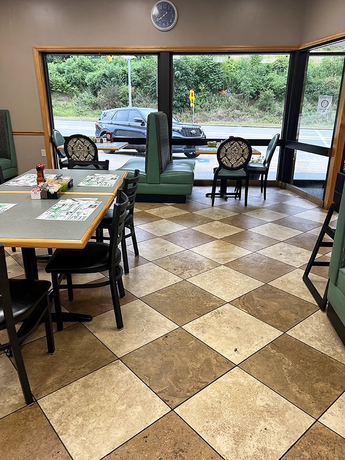 Checkerboard floors and green booth seating create that perfect diner atmosphere where comfort trumps trendiness and conversations flow as freely as the coffee.