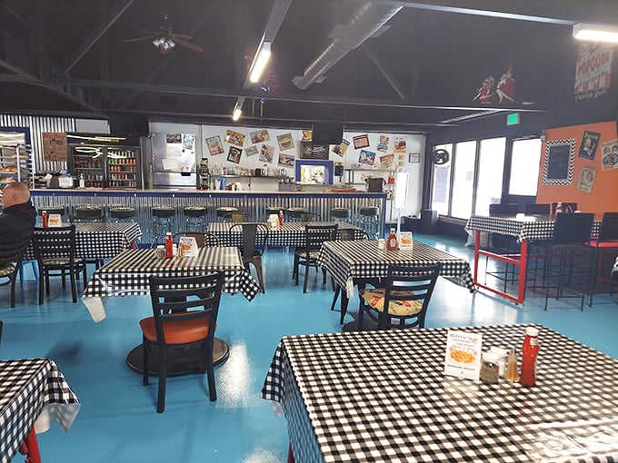 Black and white checkered tablecloths meet bright blue floors in this time capsule of Americana. The diner's interior feels like stepping into a simpler, more delicious era.