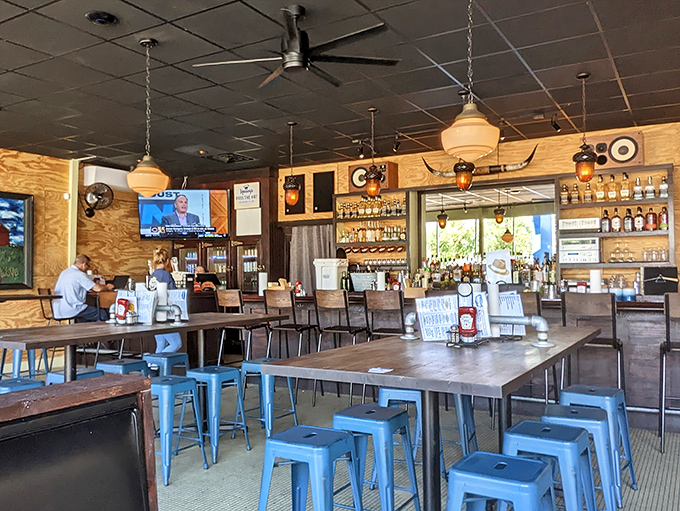 Industrial chic meets Southern comfort in Heavy's dining room. Those blue metal stools aren't just stylish—they're perfectly positioned for maximum burger-to-mouth efficiency.