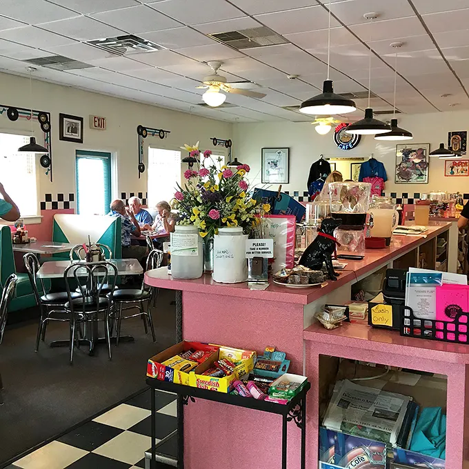 Pink countertops and checkered floors transport you to a bygone era where conversation flows as freely as the coffee.