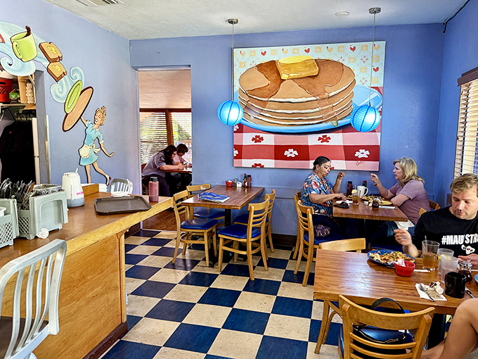 Blue walls, whimsical pancake art, and that classic checkered floor—this isn't just a restaurant, it's breakfast's natural habitat.