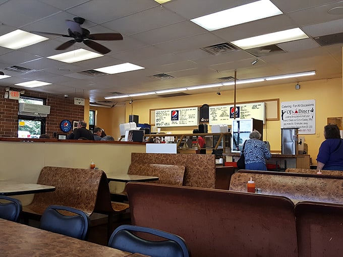 Simple booths, no-nonsense ceiling fans, and that comforting yellow glow - the dining room at OJ's promises authenticity before you even see a menu.
