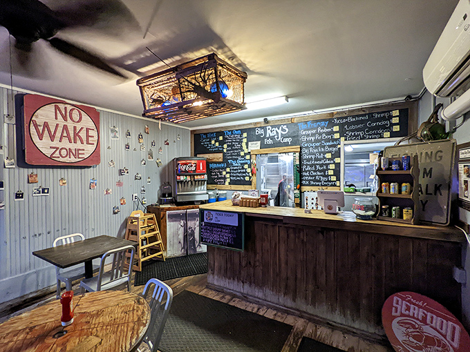 Inside, the "No Wake Zone" sign isn't just nautical decor—it's sound advice when you're moving through this cozy space with a tray full of seafood gold.
