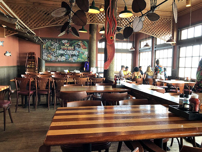 Wooden tables, ceiling fans, and nautical decor create that perfect "I'm on vacation" atmosphere without veering into tacky souvenir shop territory.