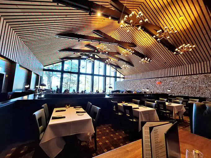 Soaring wooden ceilings and dramatic pendant lights create an atmosphere that's both grand and intimate – Wisconsin supper club elegance reimagined for today's diners.