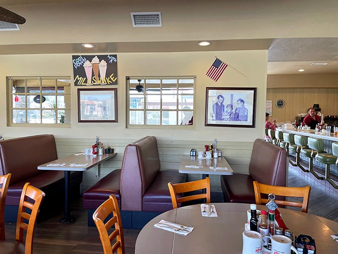 Classic burgundy booths and nostalgic decor create that perfect diner atmosphere—where conversations flow as freely as the coffee.