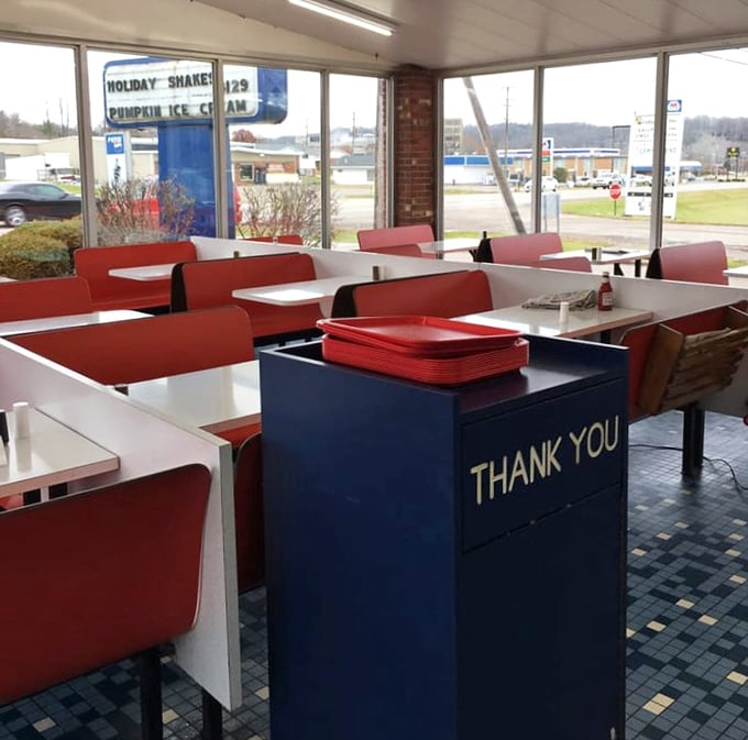 Red vinyl booths and checkerboard floors transport you straight to the 1950s. That blue "Thank You" trash bin? Pure Americana.