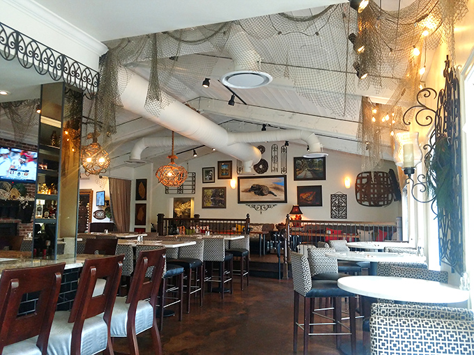 Fishing nets and warm lighting create an atmosphere that's equal parts coastal charm and rustic elegance. Somewhere between fancy and "I could nap here after eating."