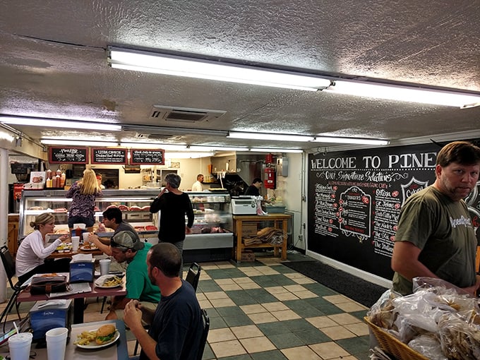 Inside, the no-frills charm of checkered floors and chalkboard menus creates that rare atmosphere where strangers become friends over exceptional food.
