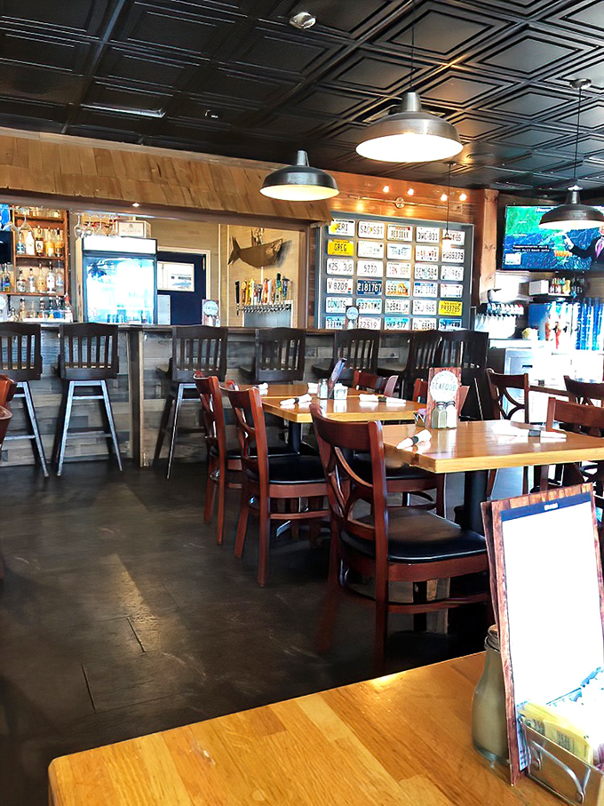 License plates from across America adorn walls beneath classic tin ceiling panels—silent testimony that people will travel surprising distances for truly exceptional seafood.