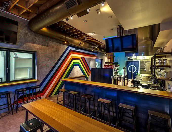 Industrial-chic meets playful design with this rainbow stripe wall that says, "Yes, we take our food seriously, but ourselves? Not so much."