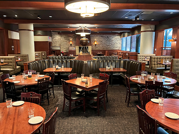 Warm wood tones, comfortable leather booths, and stone accents create an atmosphere that's sophisticated yet welcoming—like a backyard barbecue that went to finishing school.