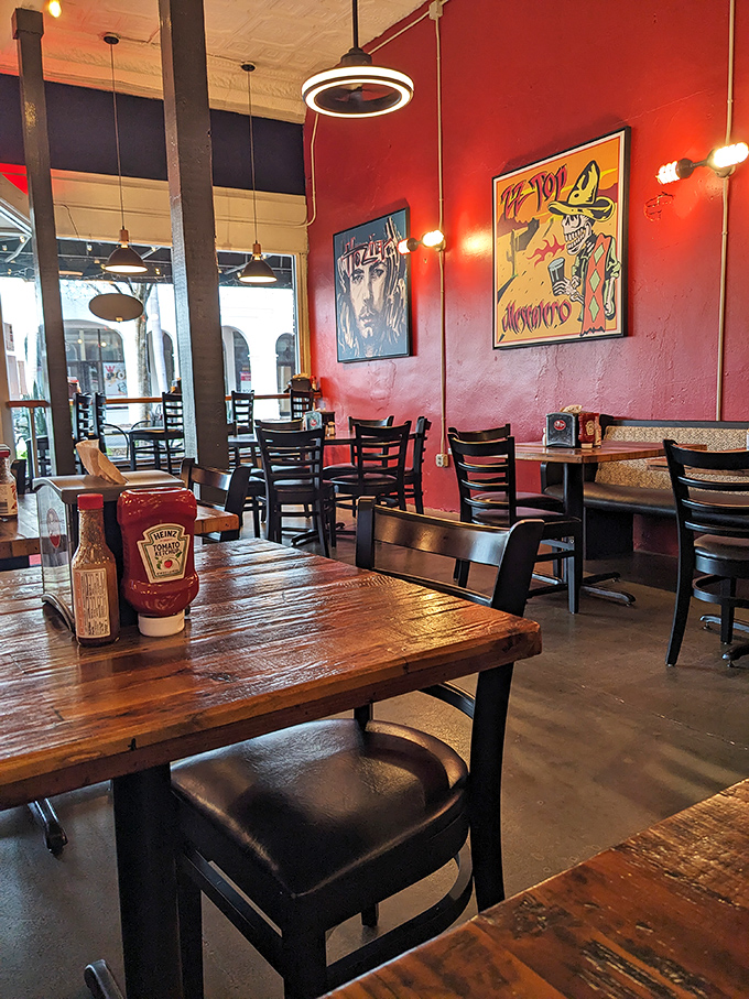 Red walls, wooden tables, and eclectic art create the perfect backdrop for burger bliss. This isn't just dining—it's a flavor sanctuary.
