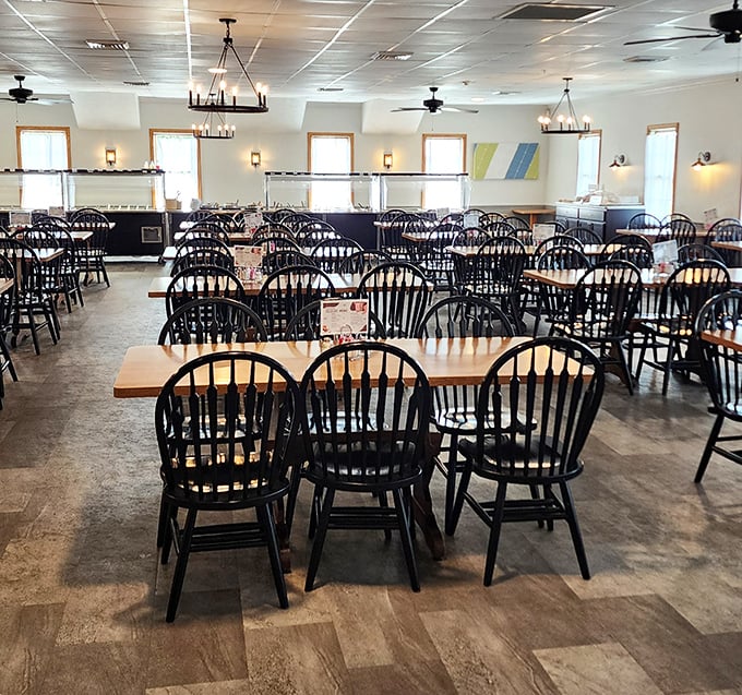 Black Windsor chairs and simple wooden tables create an atmosphere of honest comfort. No pretension here—just a space designed for the serious business of enjoying good food.