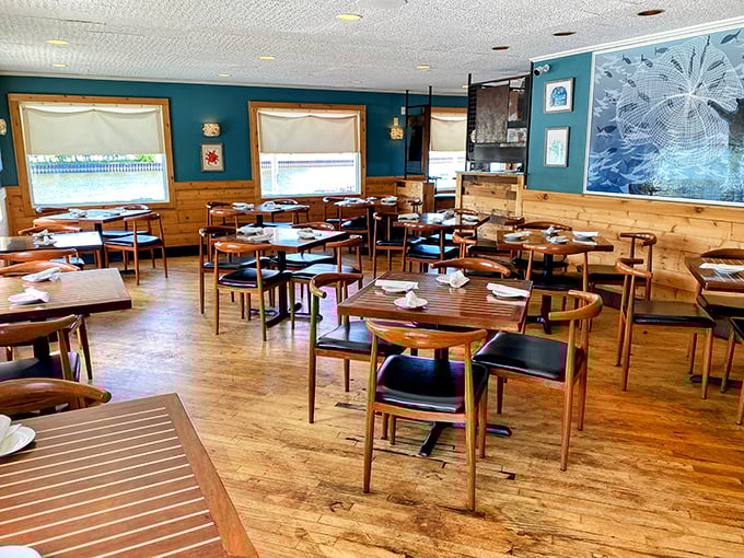 Teal walls meet wooden warmth in a dining room that feels like Cape Cod took a Midwest vacation. Those mid-century chairs aren't just stylish—they're inviting you to stay awhile.