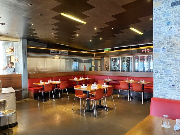 Red vinyl booths and industrial chic vibes create the perfect backdrop for seafood indulgence—like a maritime dream with better lighting.