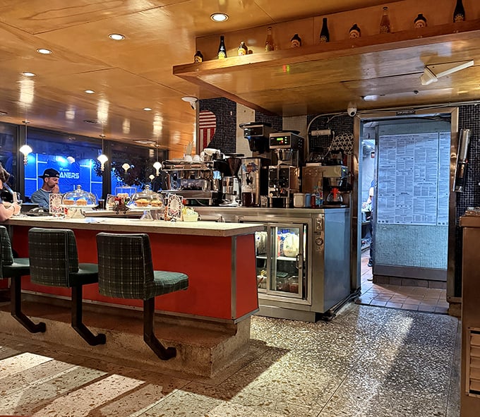 Counter culture at its finest – where the warm wood ceiling, retro stools, and bustling kitchen create the perfect backdrop for your morning coffee ritual.